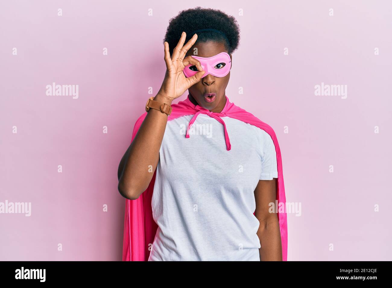 Young african american girl wearing superhero mask and cape costume ...