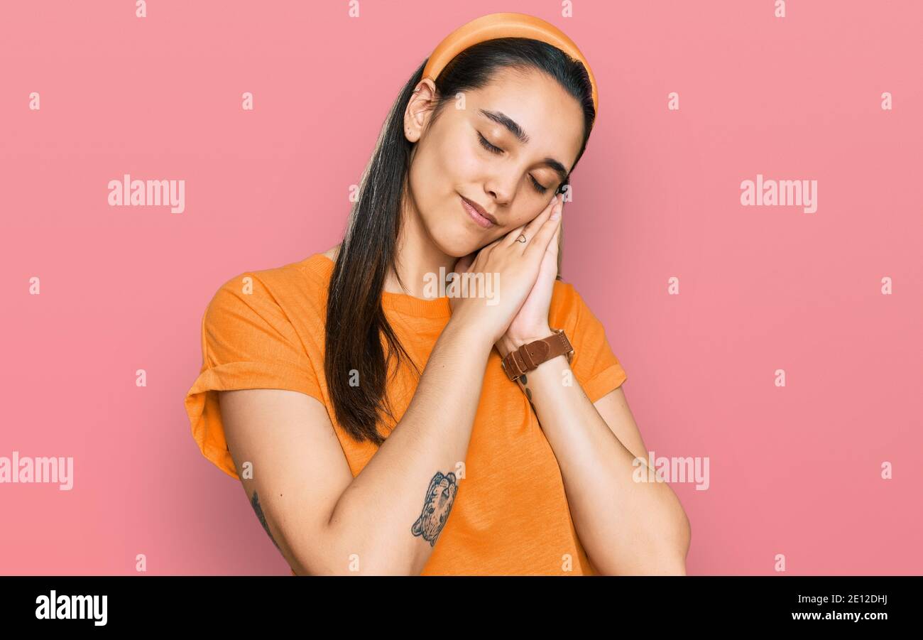 Young Hispanic Woman Wearing Casual Clothes Sleeping Tired Dreaming And