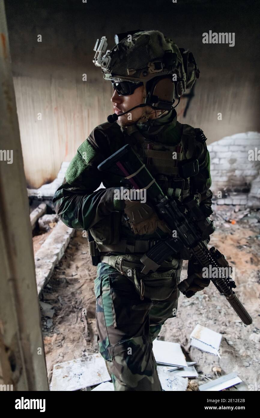 Front view close up of caucasian soldier with a rifle stand guard ...