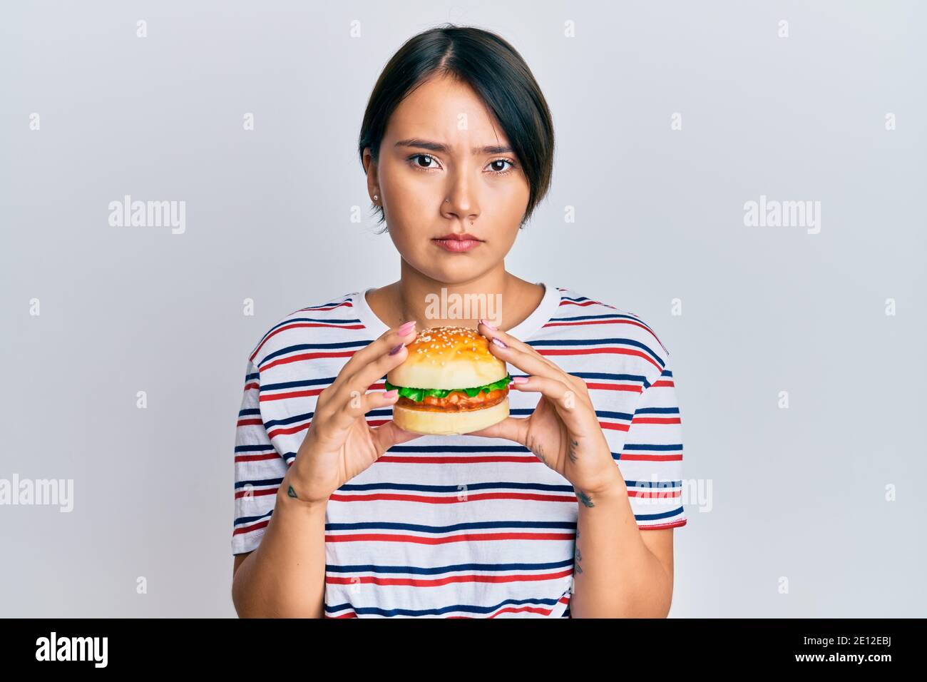Nervous person eating hamburger hi-res stock photography and images - Alamy