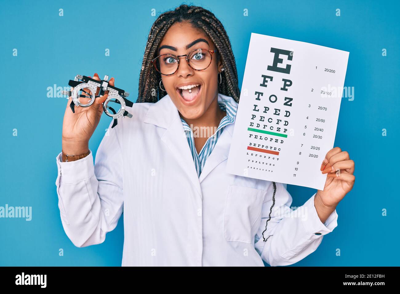 Young african american optician woman with braids holding optometry ...