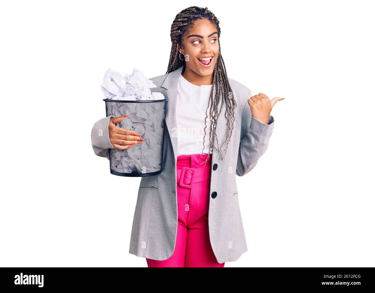 Young african american woman with braids holding paper bin full of ...