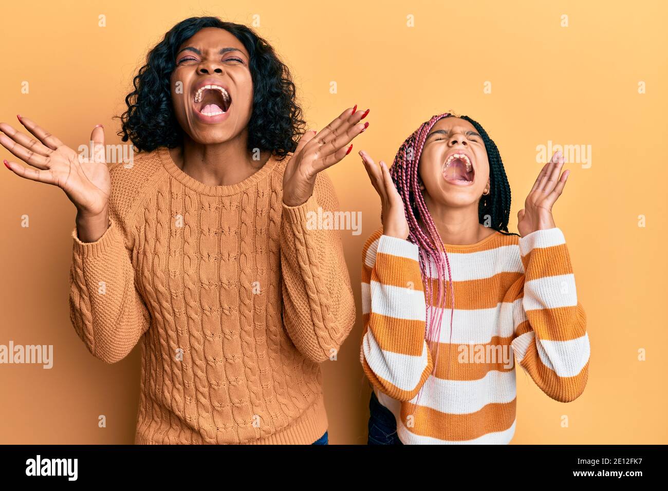 Beautiful african american mother and daughter wearing wool winter ...