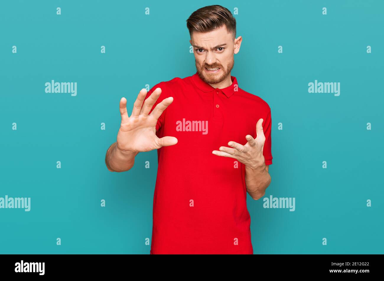 Young redhead man wearing casual clothes disgusted expression ...