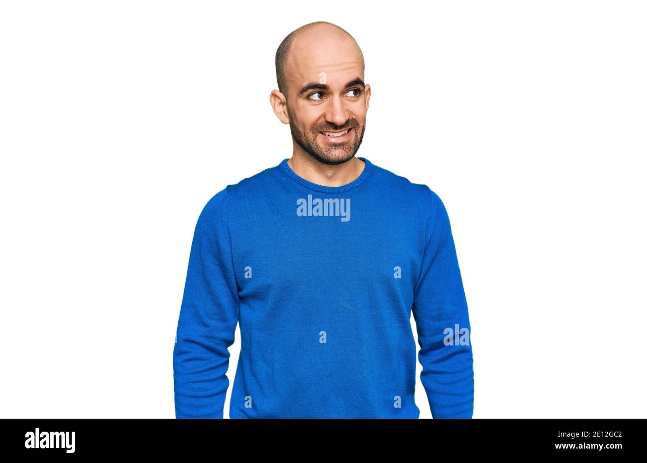 Young hispanic man wearing casual clothes looking away to side with ...