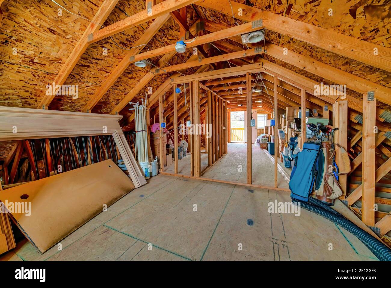 Interior of the attic of a house with pitched roof and used as storage ...