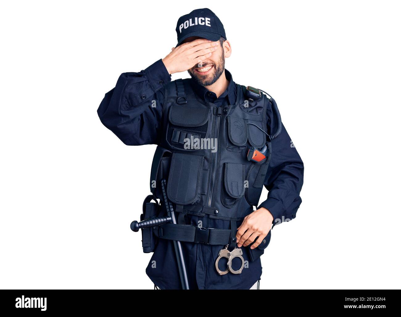 Young handsome man with beard wearing police uniform smiling and ...