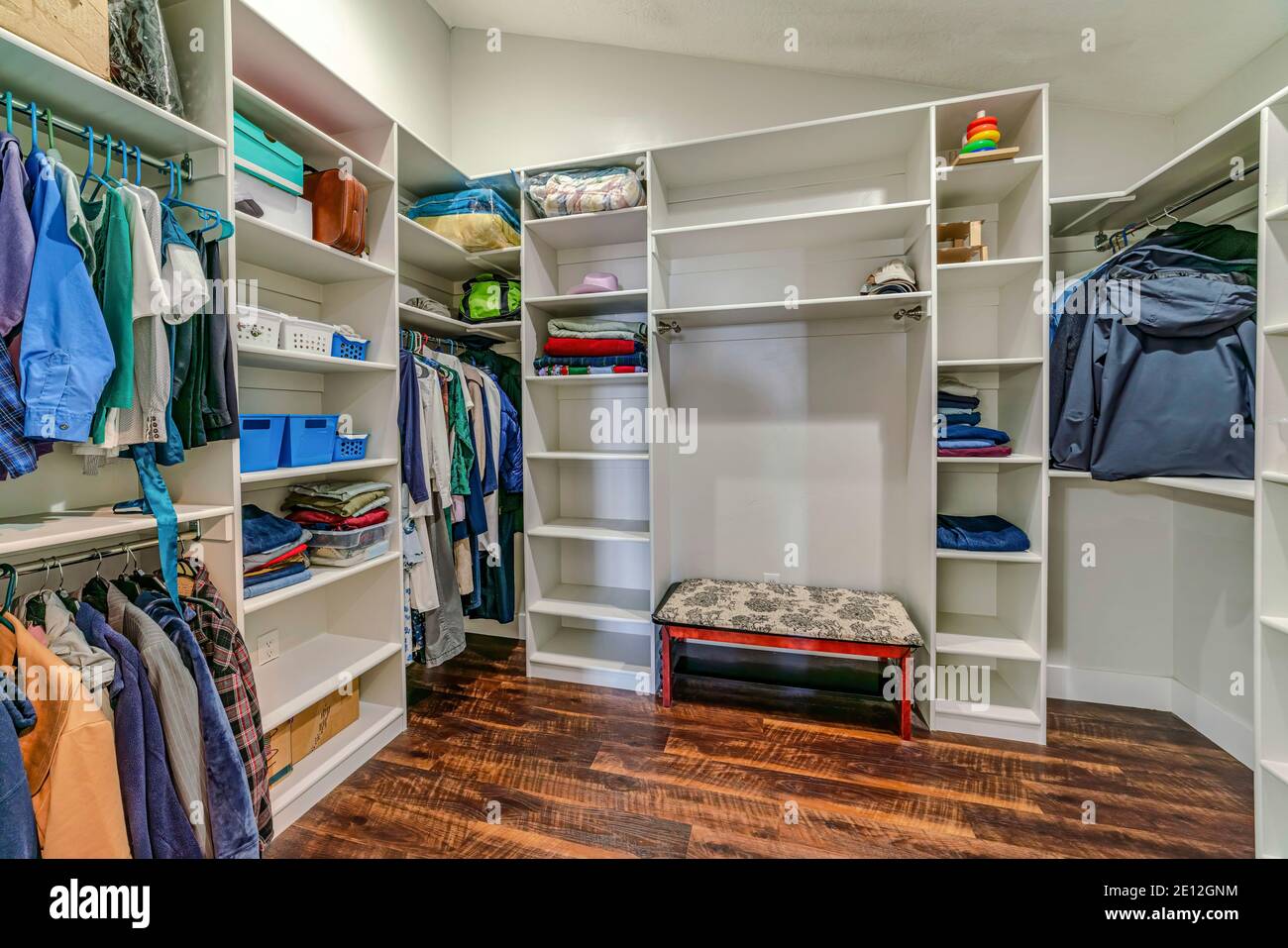 Interior view of walk in closet with built in storage shelves and ...