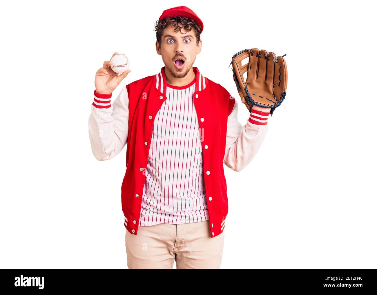 Young handsome man with curly hair wearing baseball uniform holding ...