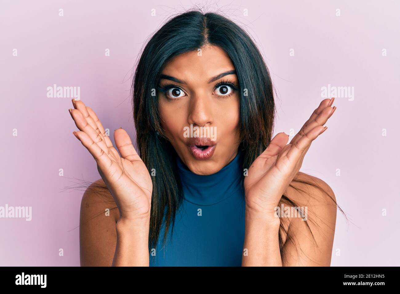 Young latin transsexual transgender woman with hands over face afraid ...