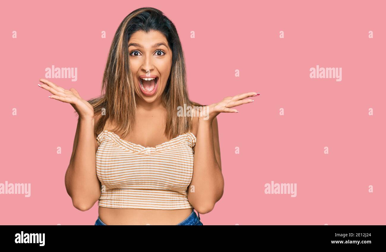 Beautiful brunette woman wearing casual clothes celebrating crazy and ...