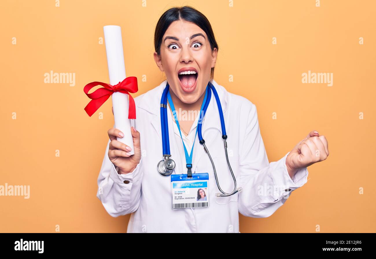 Young beautiful doctor woman wearing stethoscope holding diploma degree ...