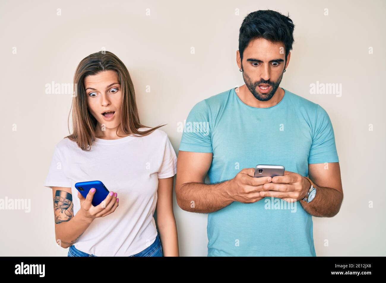 Beautiful young couple of boyfriend and girlfriend using smartphone ...