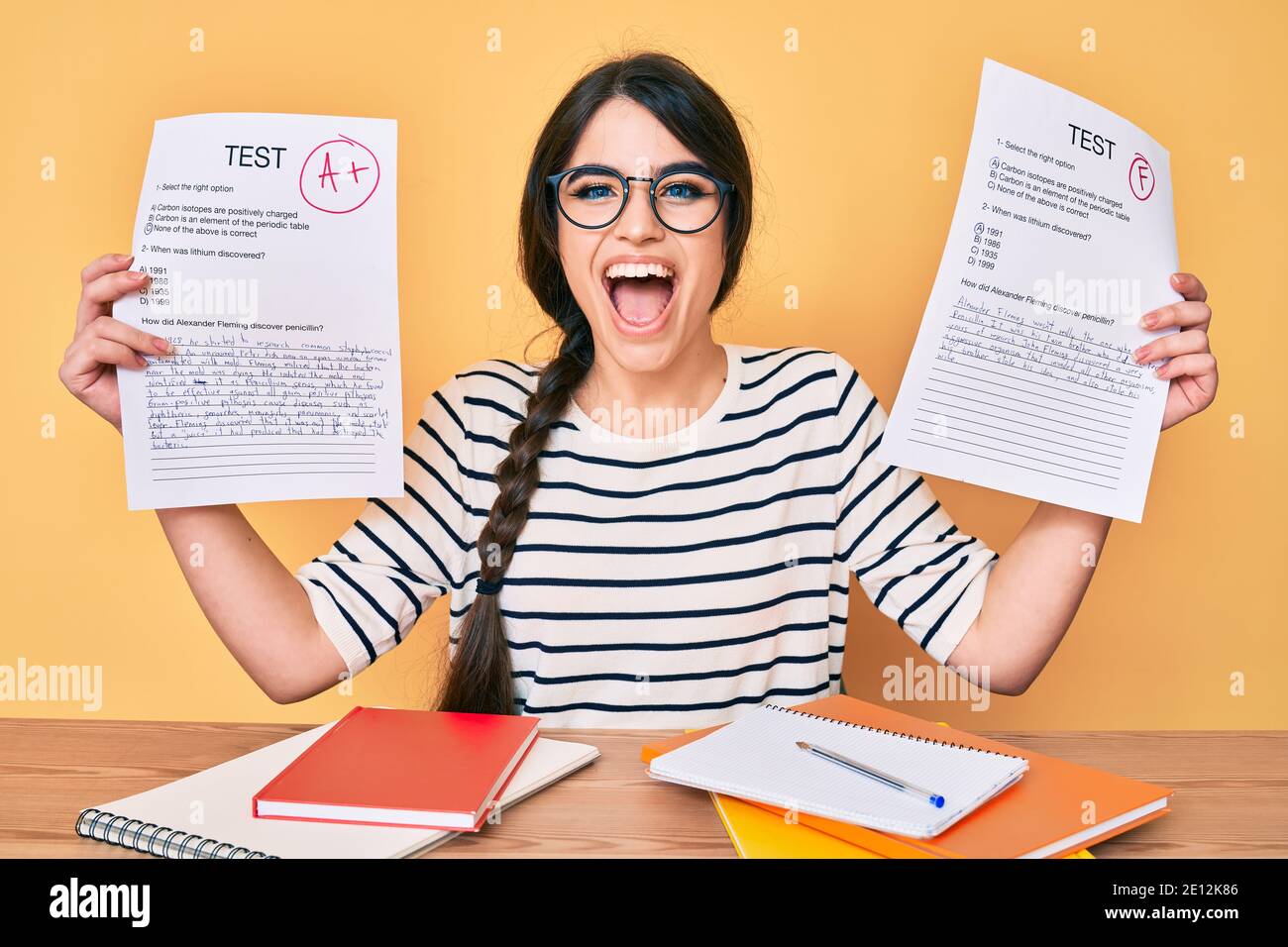 Brunette teenager girl showing failed and passed exam smiling and ...