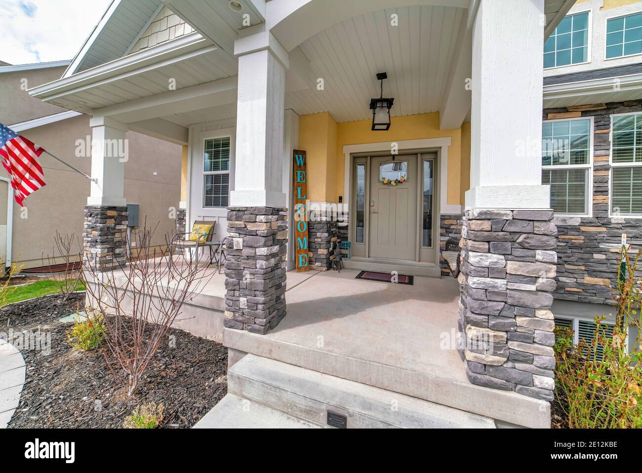 Home with arched entrance to the open porch and front door with ...