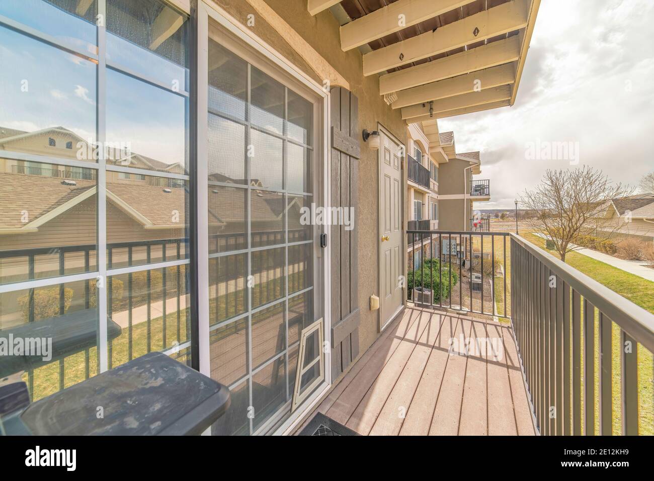 Window with shutters and gray door at the balcony of home with roof ...