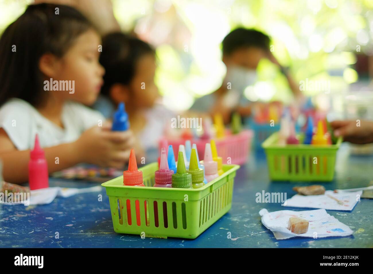An out of focus picture of a group of students taking an art lesson ...