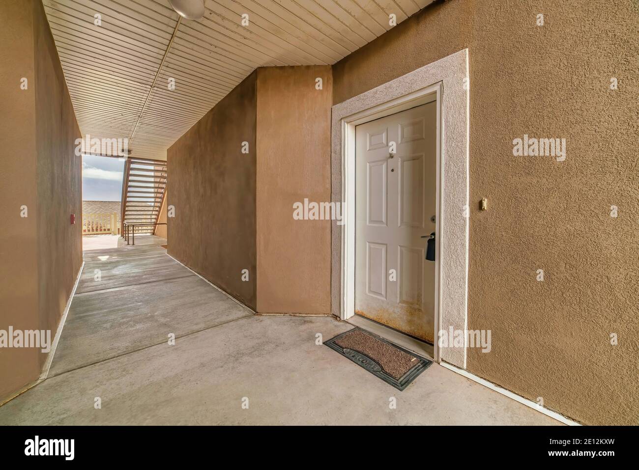 Entrance to house at first floor of an apartment building with white ...