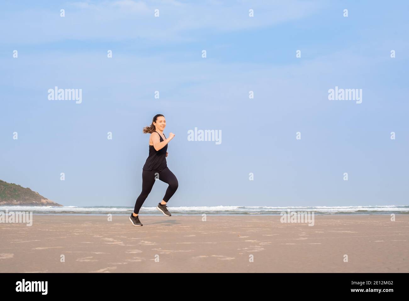 Woman running at the beach hi-res stock photography and images - Alamy
