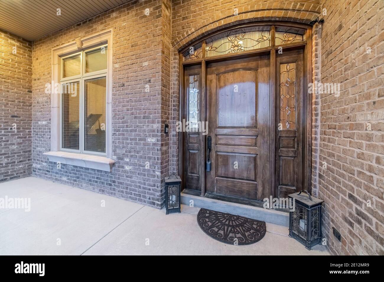 Beautiful facade of house with front door and window against stone ...