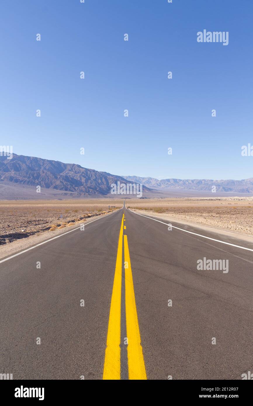 An empty road running straight through Death Valley National Park Stock ...