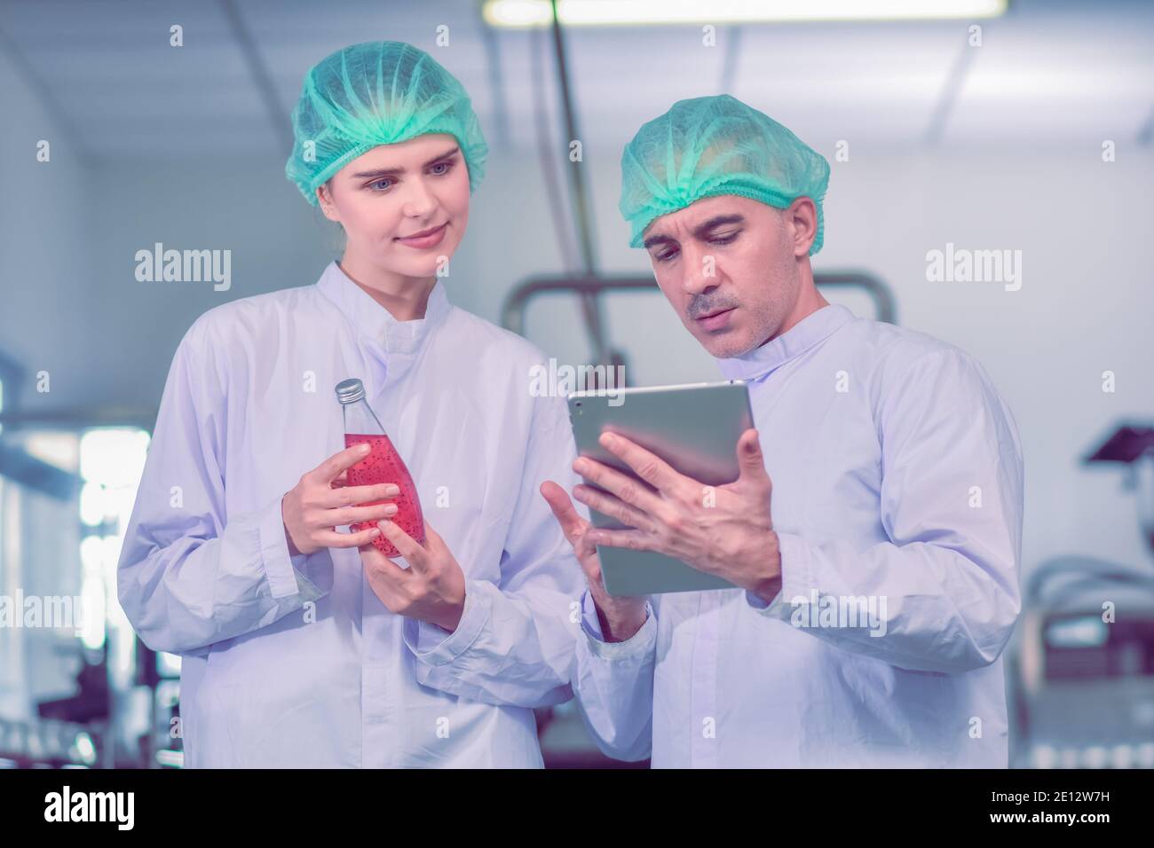 Worker people check quality control in production process beverage in ...
