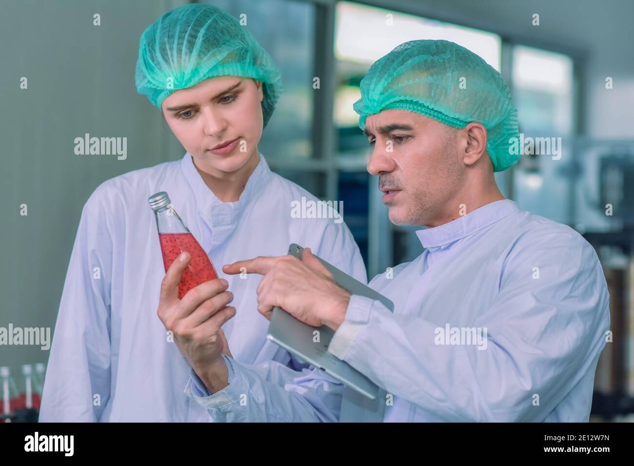 Worker people check quality control in production process beverage in ...