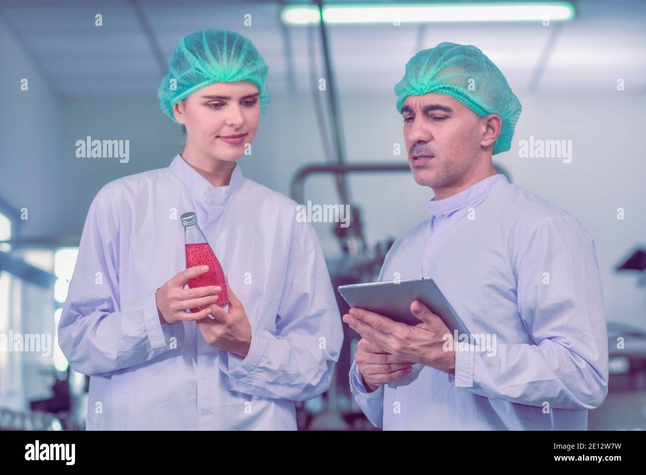 Worker people check quality control in production process beverage in ...
