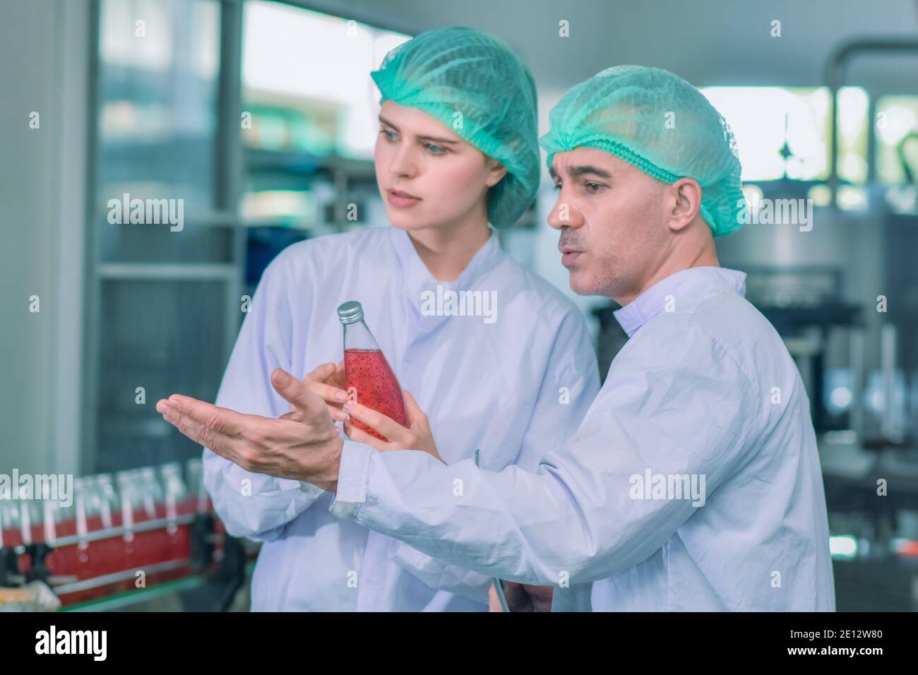 Worker people check quality control in production process beverage in ...