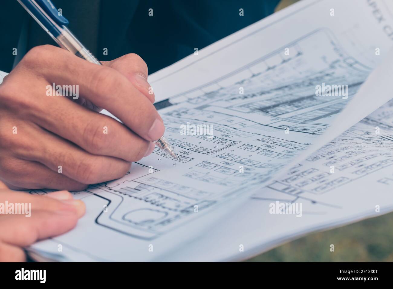 Close up hand write on paper blueprint checking building construction ...