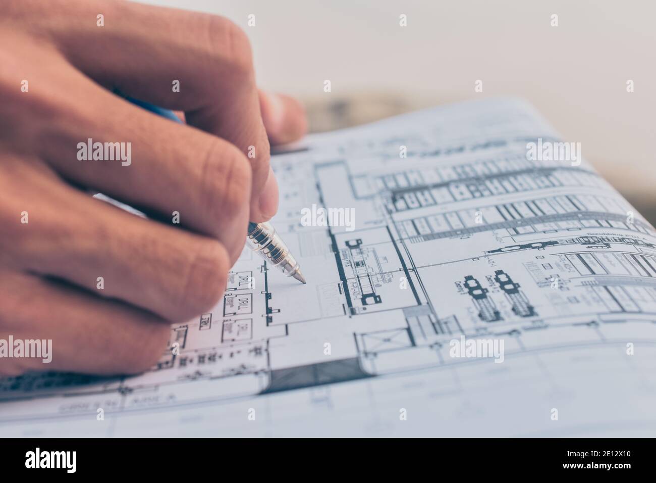 Close up hand write on paper blueprint checking building construction ...