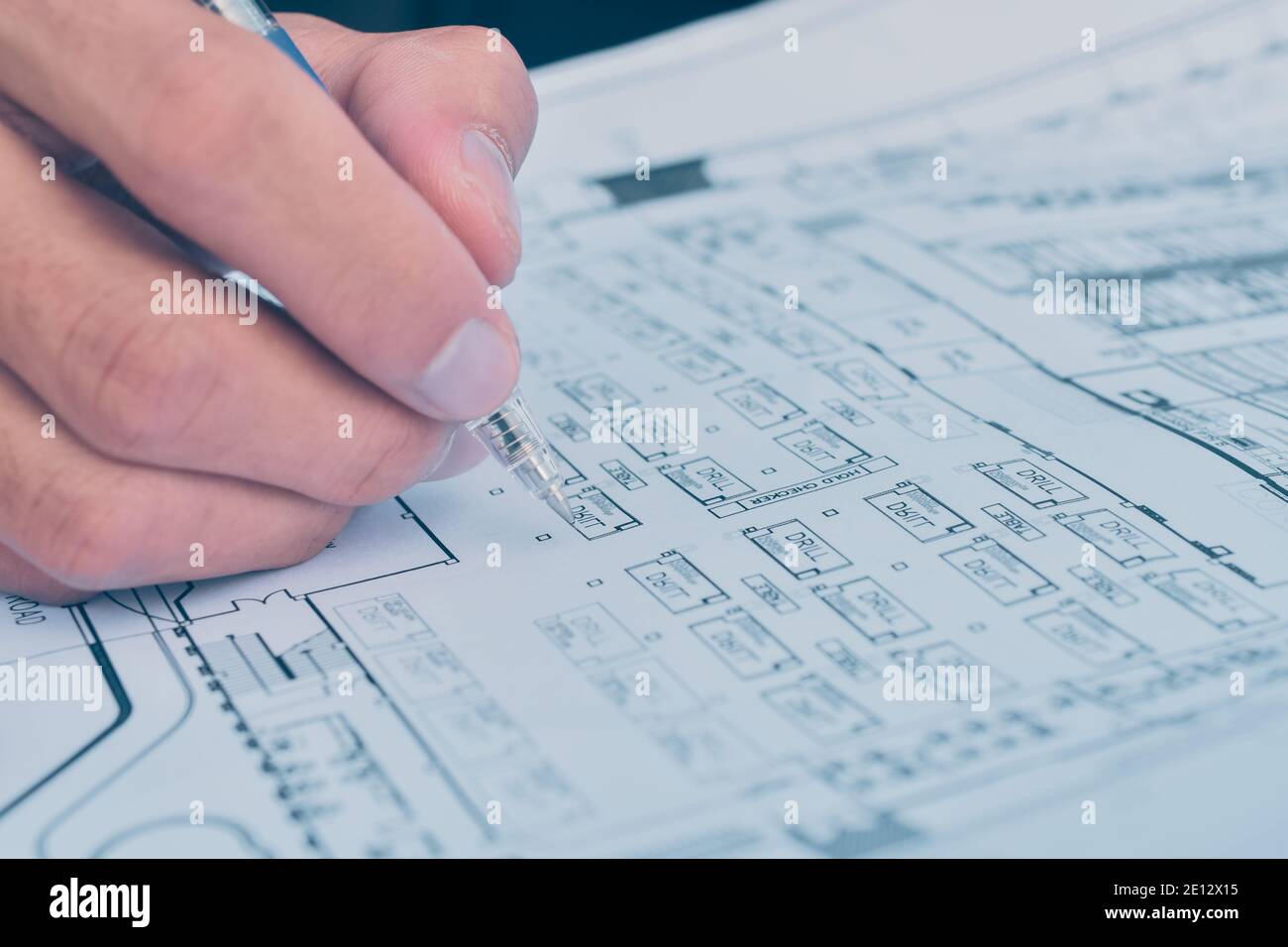 Close up hand write on paper blueprint checking building construction ...