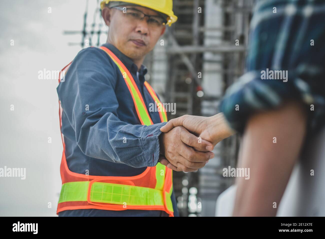 Shake hand concept, two engineer shake hand on site construction to ...