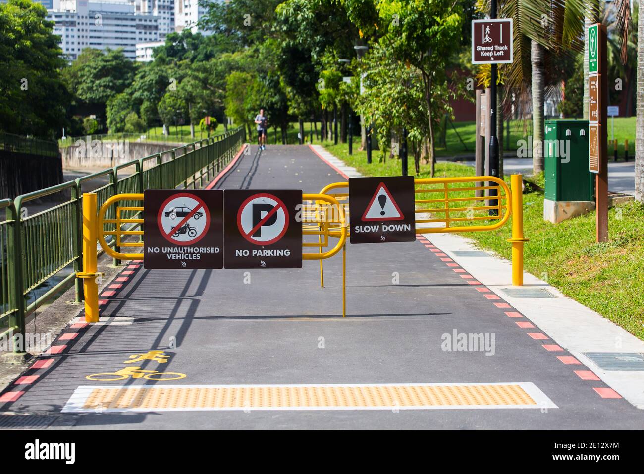 Park connector, yellow barriers and signboards instructions for park ...