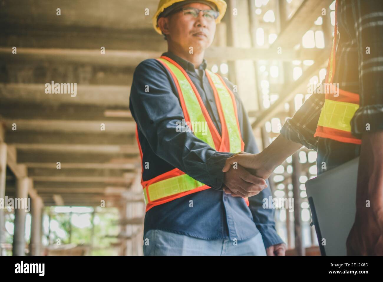 Shake hand concept, two engineer shake hand on site construction to ...