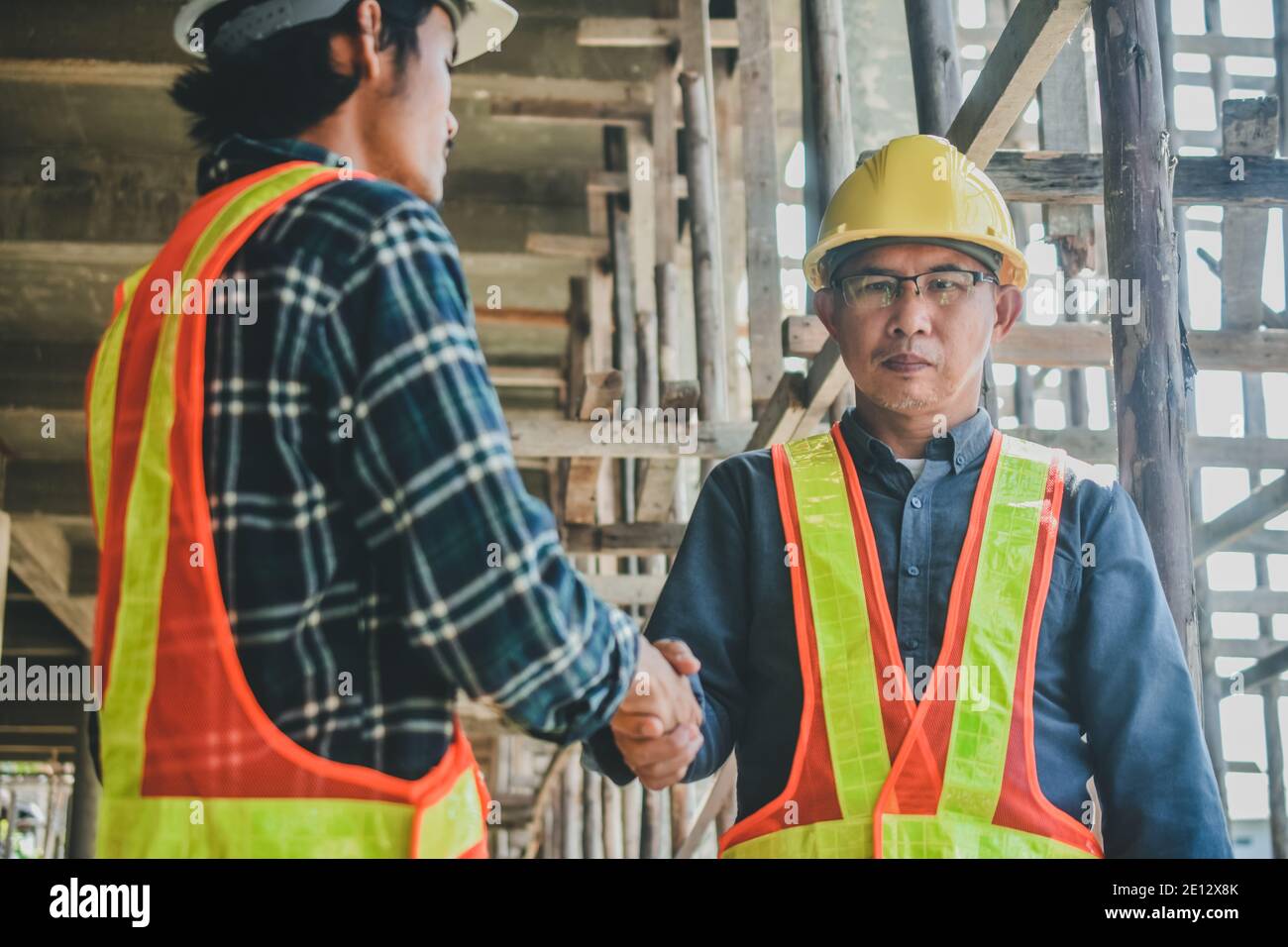 Shake hand concept, two engineer shake hand on site construction to ...