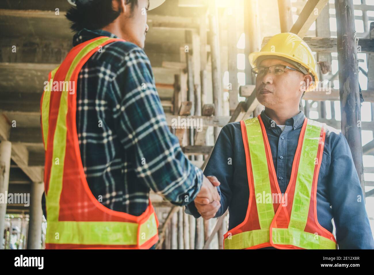 Shake hand concept, two engineer shake hand on site construction to ...