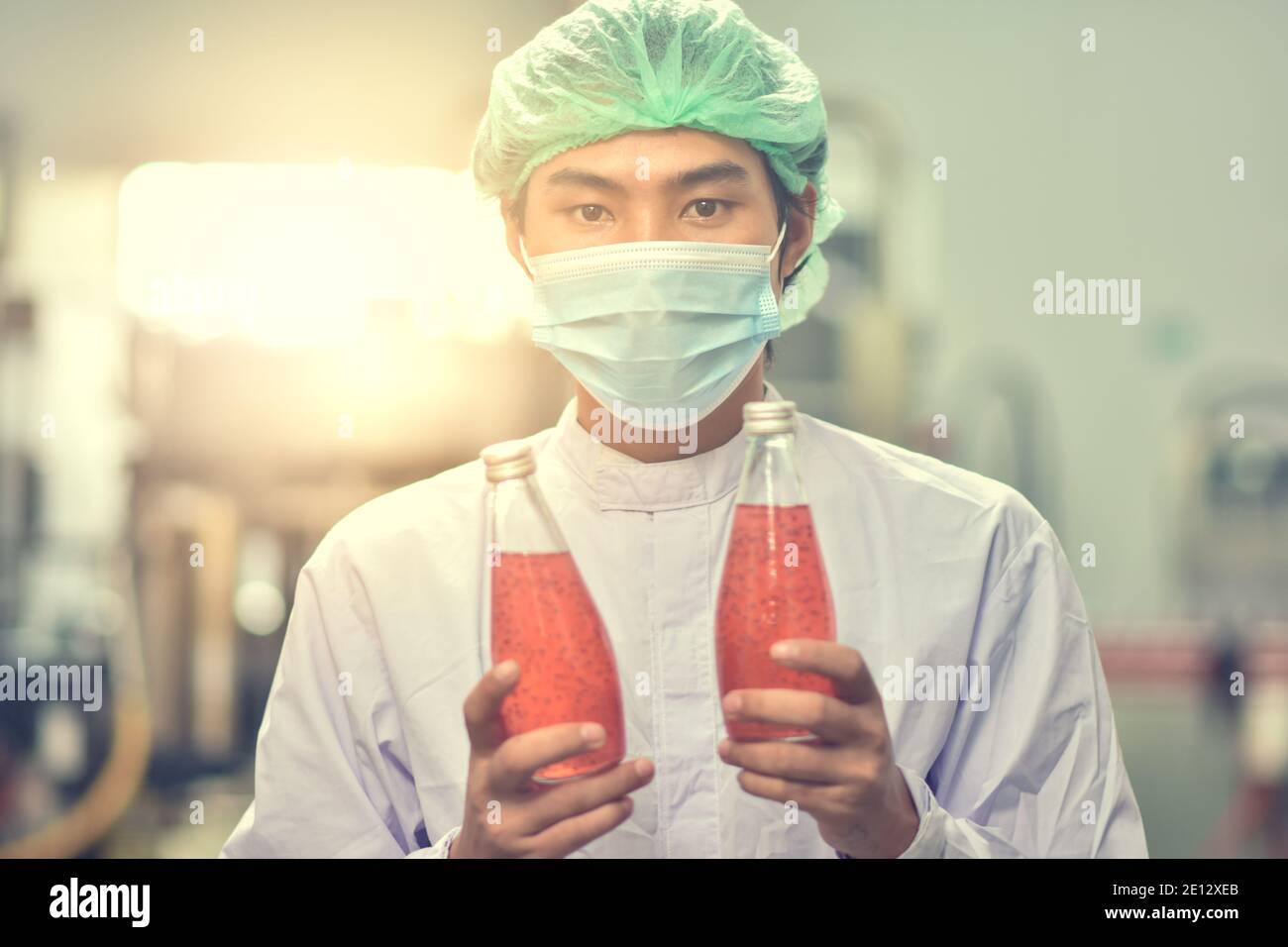 Man inspection quality control in beverage factory Stock Photo - Alamy