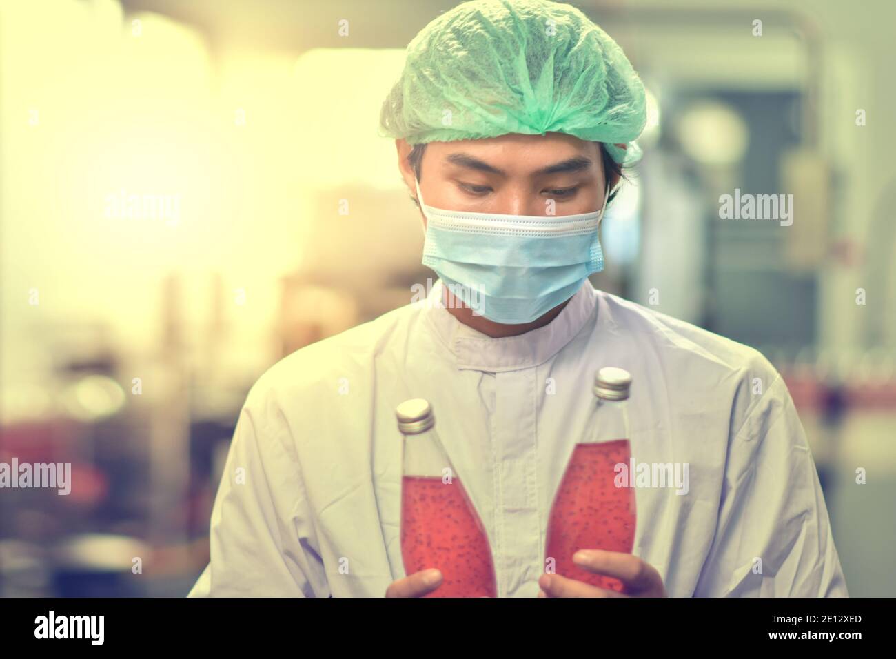 Man inspection quality control in beverage factory Stock Photo - Alamy