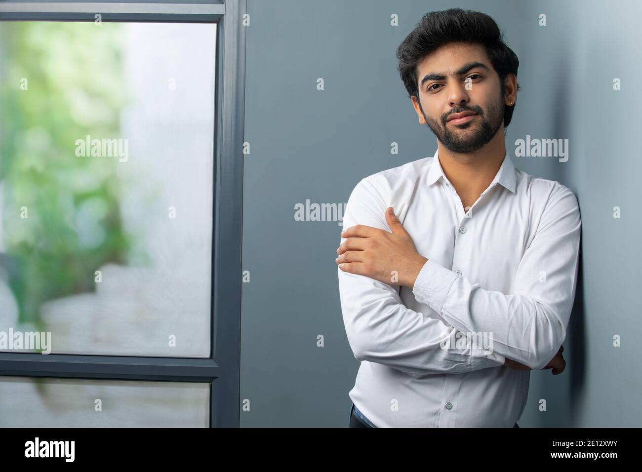 AN OFFICE EXECUTIVE STANDING AND LOOKING AT CAMERA Stock Photo - Alamy