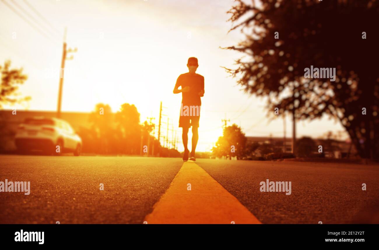 Blurry subject Man running on road Stock Photo - Alamy