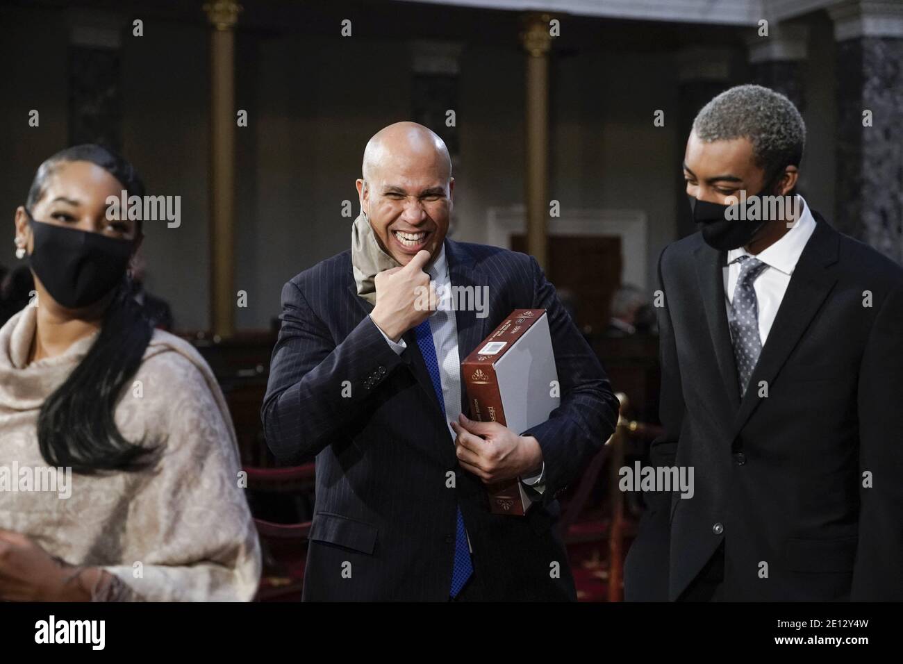 Sen. Cory Booker, D-N.J., flanked by family members, smiles after ...
