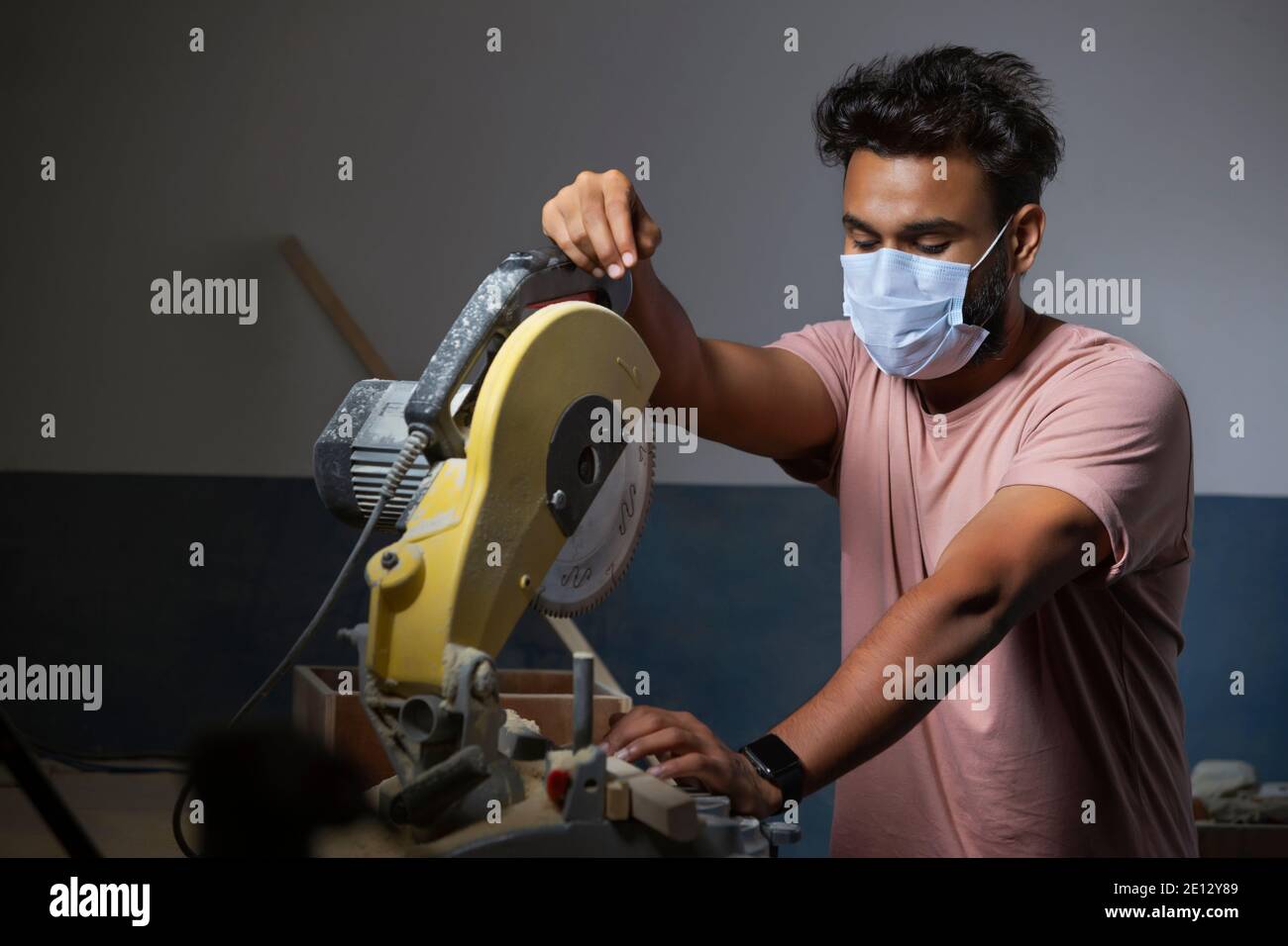 A CARPENTER WEARING FACE MASK DILIGENTLY DOING HIS JOB Stock Photo - Alamy