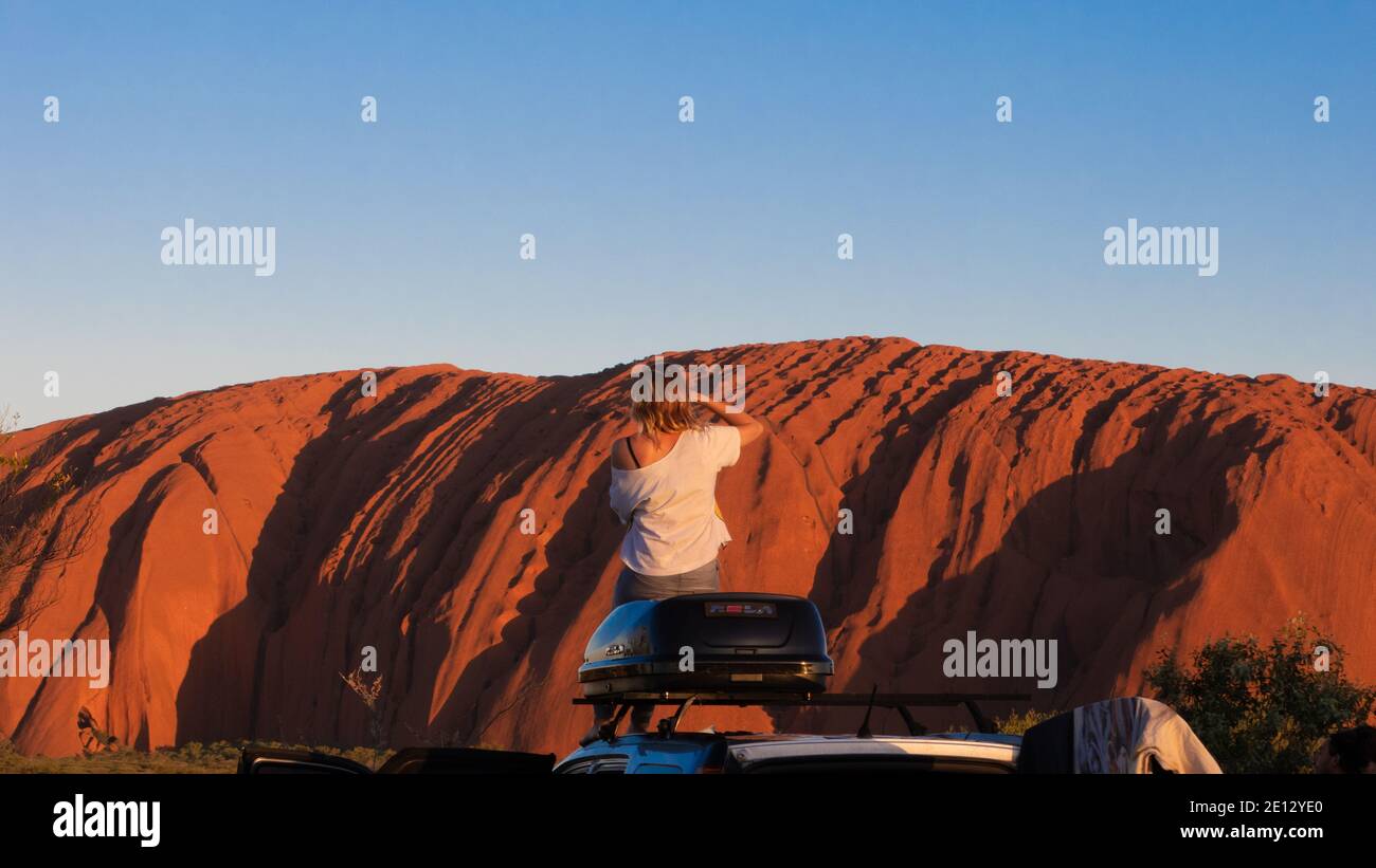 Uluru Central Australia. A tourist viewing sunset at Uluru in Uluru ...