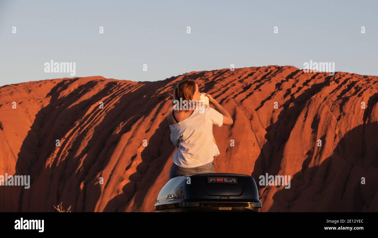 Uluru Central Australia. A tourist viewing sunset at Uluru in Uluru ...