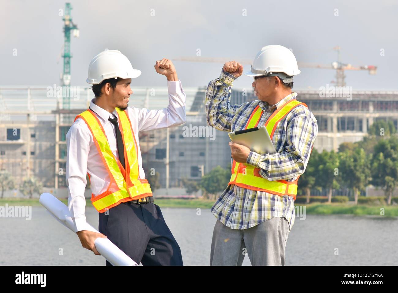 Two Engineer standing on site construction happy success,Two worker ...