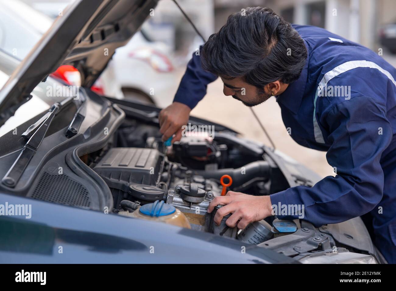A YOUNG MECHANIC WORKING ON CAR ENGINE Stock Photo - Alamy