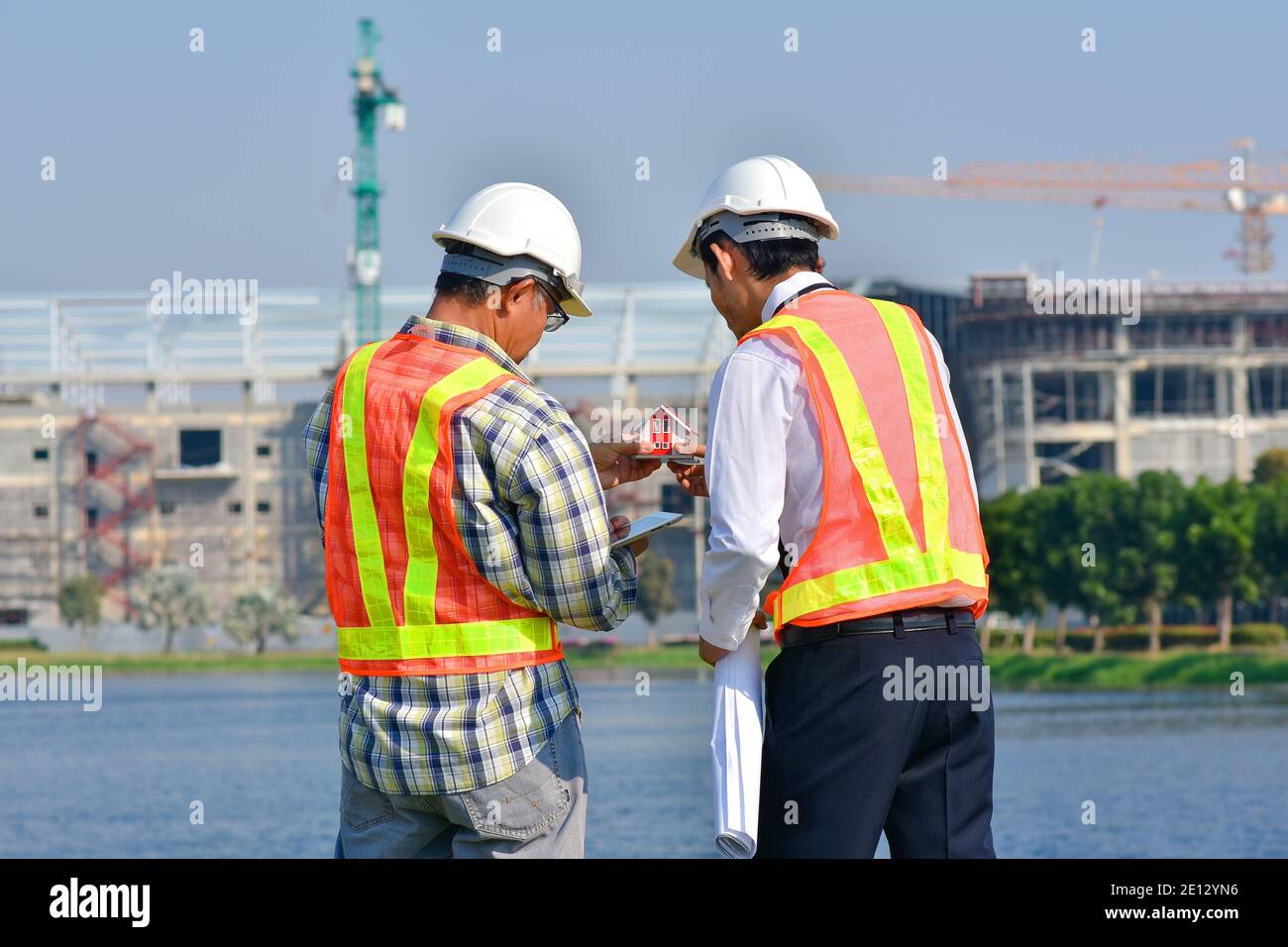 Engineer hold a blueprint for the construction factory in an industrial ...