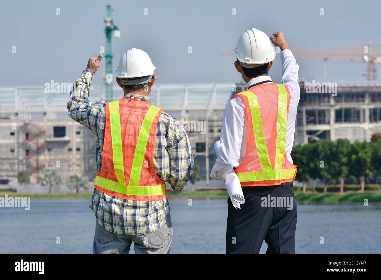Engineer hold a blueprint for the construction factory in an industrial ...