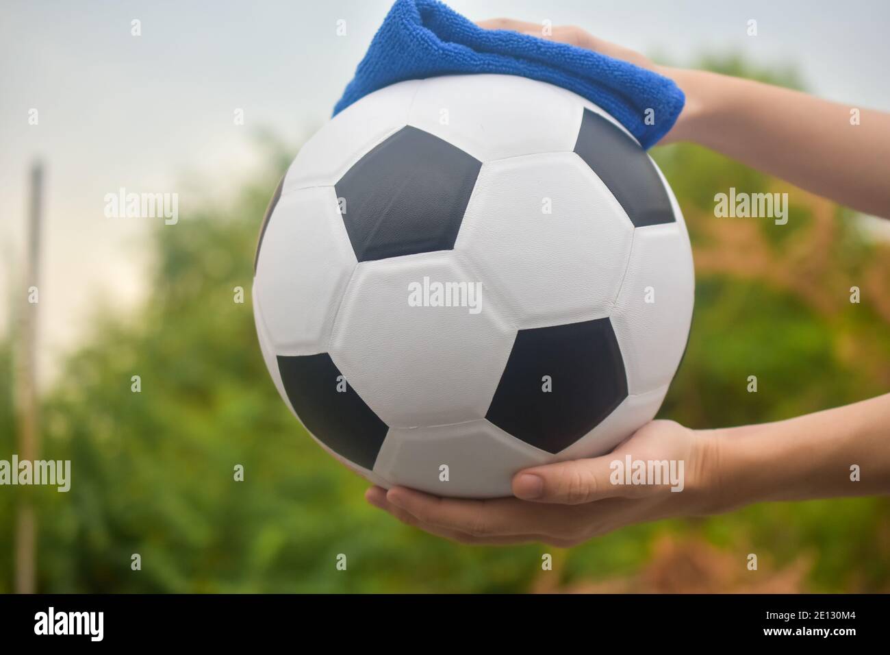 Hand holding Wiping cloth cleaning football Stock Photo - Alamy
